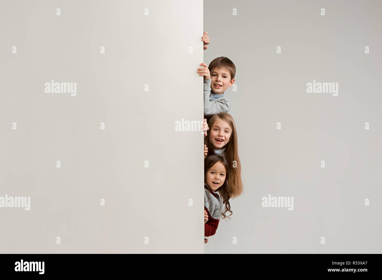 Banner with a surprised children peeking at the edge with copyspace ...
