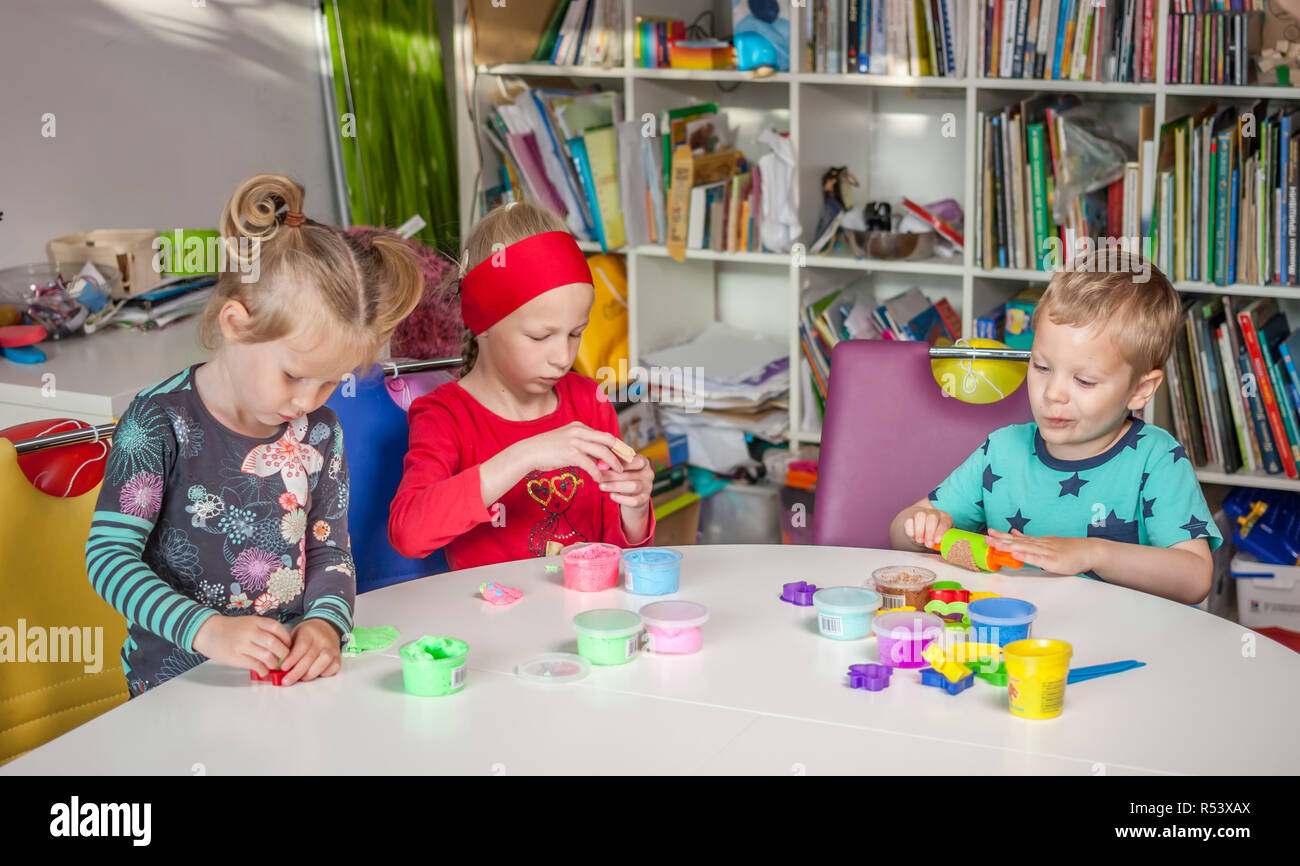 cute little kids playing with plasticine Stock Photo - Alamy