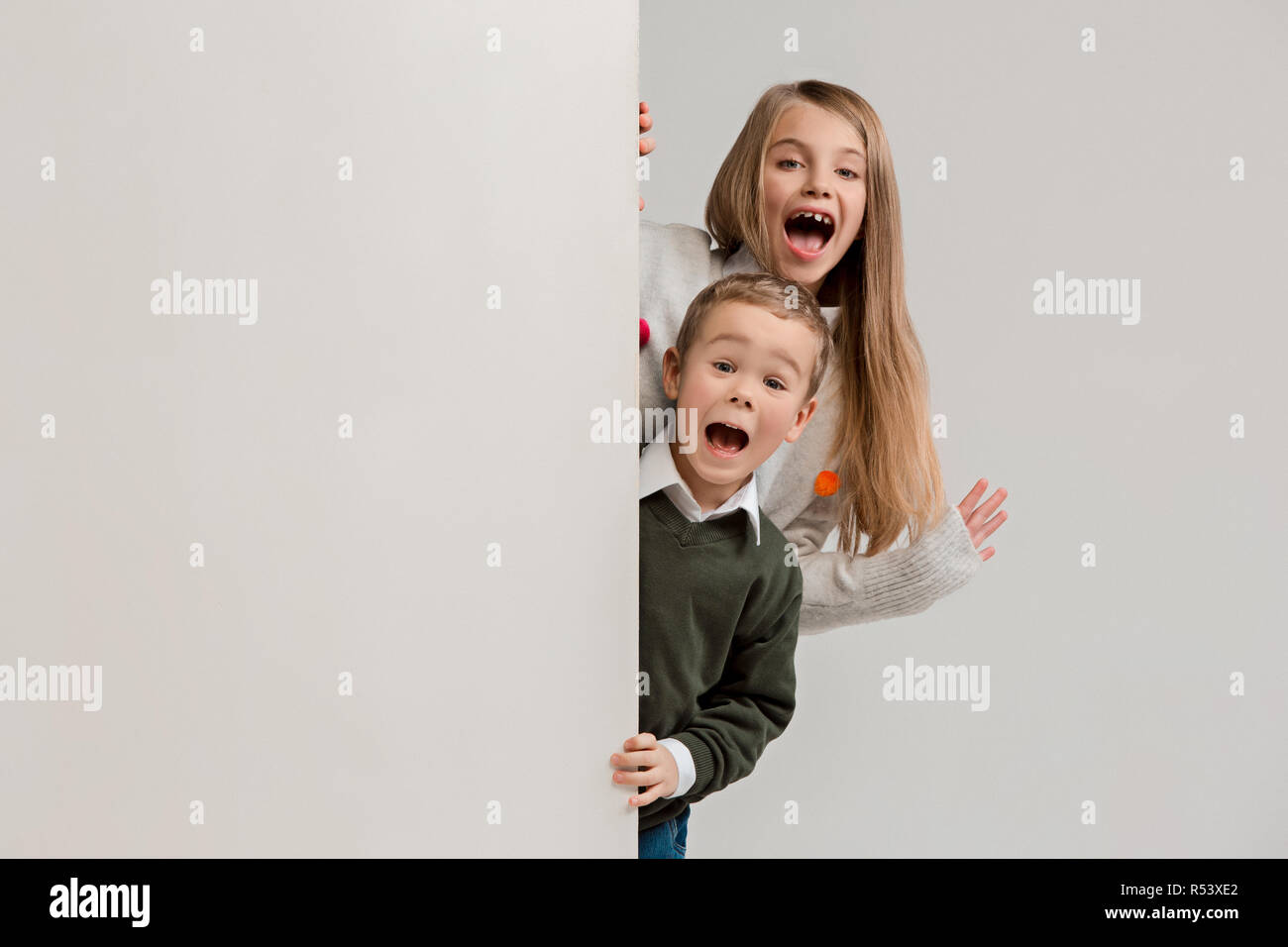 Banner with a surprised children peeking at the edge with copyspace ...
