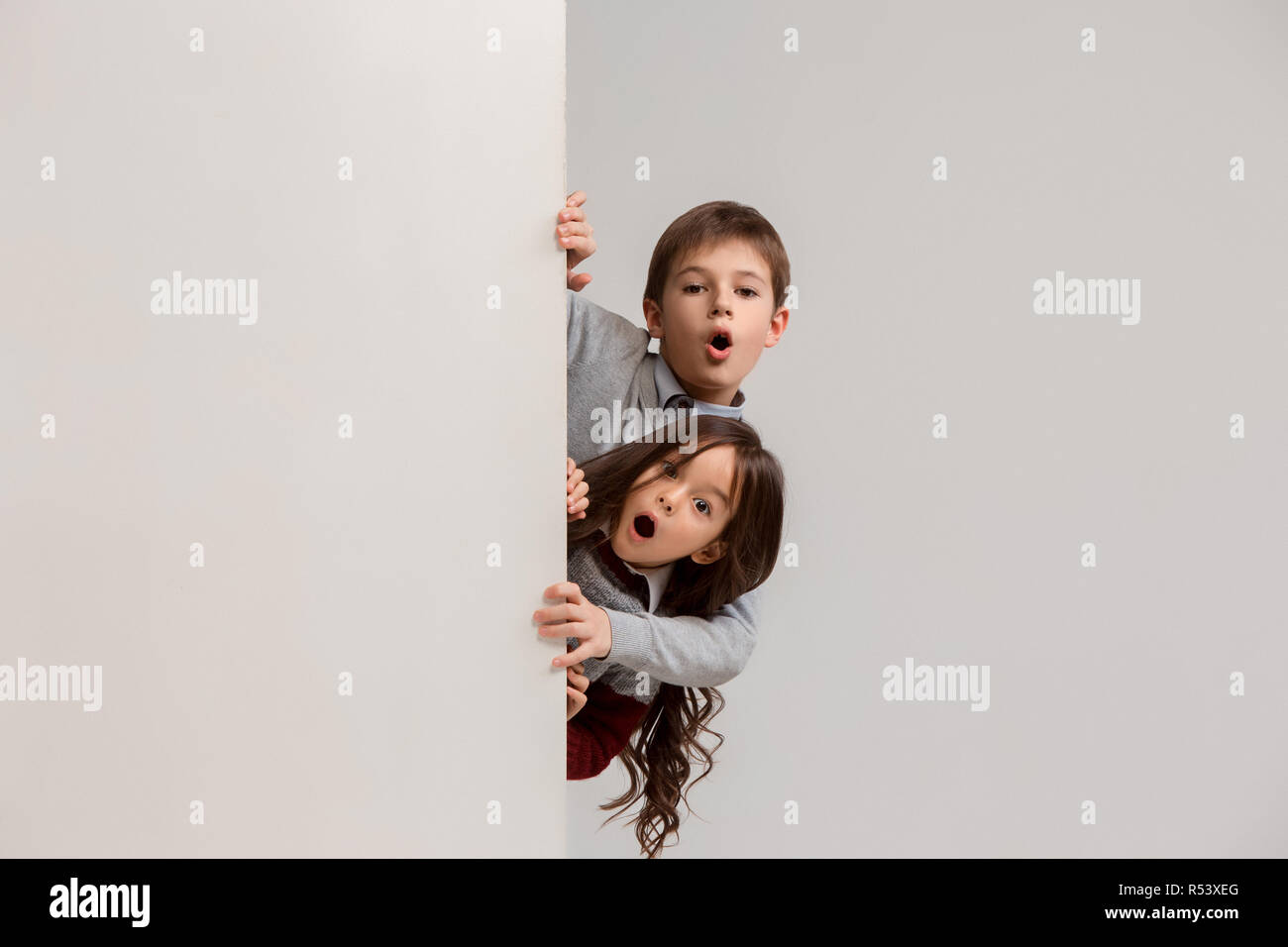Banner with a surprised children peeking at the edge with copyspace ...