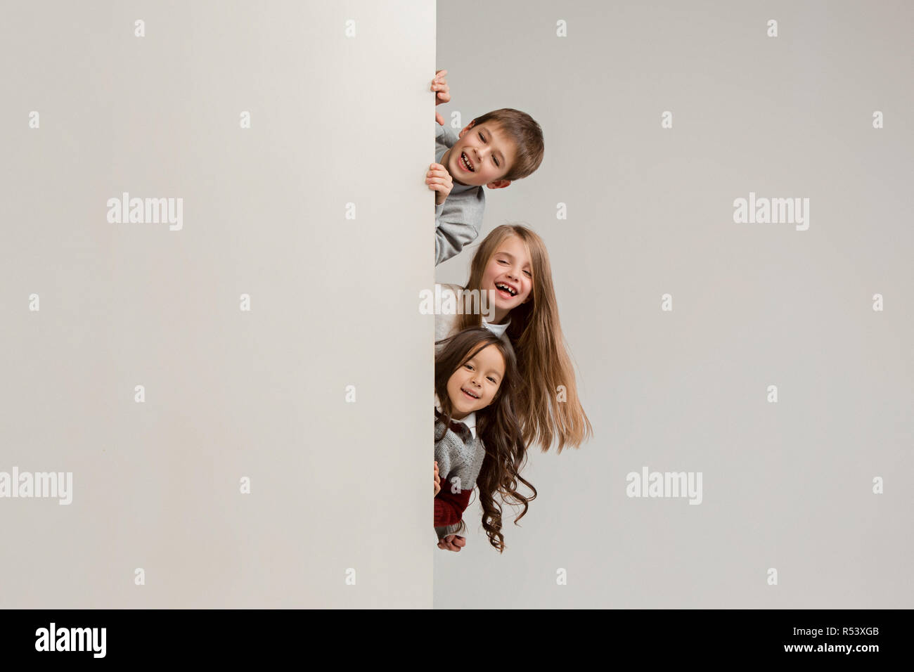 Banner with a surprised children peeking at the edge with copyspace ...