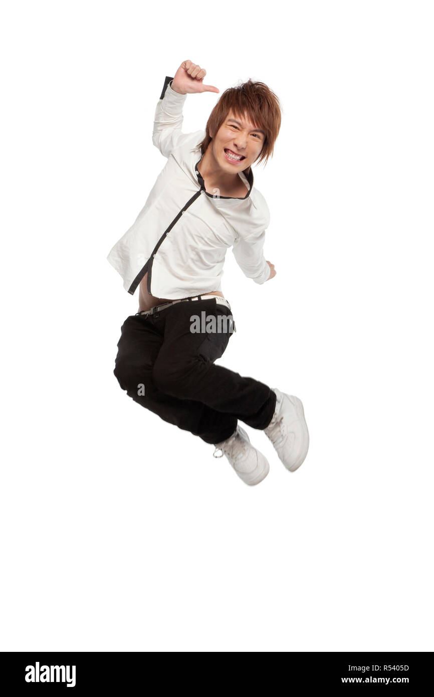 Portrait of an excited young man mid-air Stock Photo - Alamy