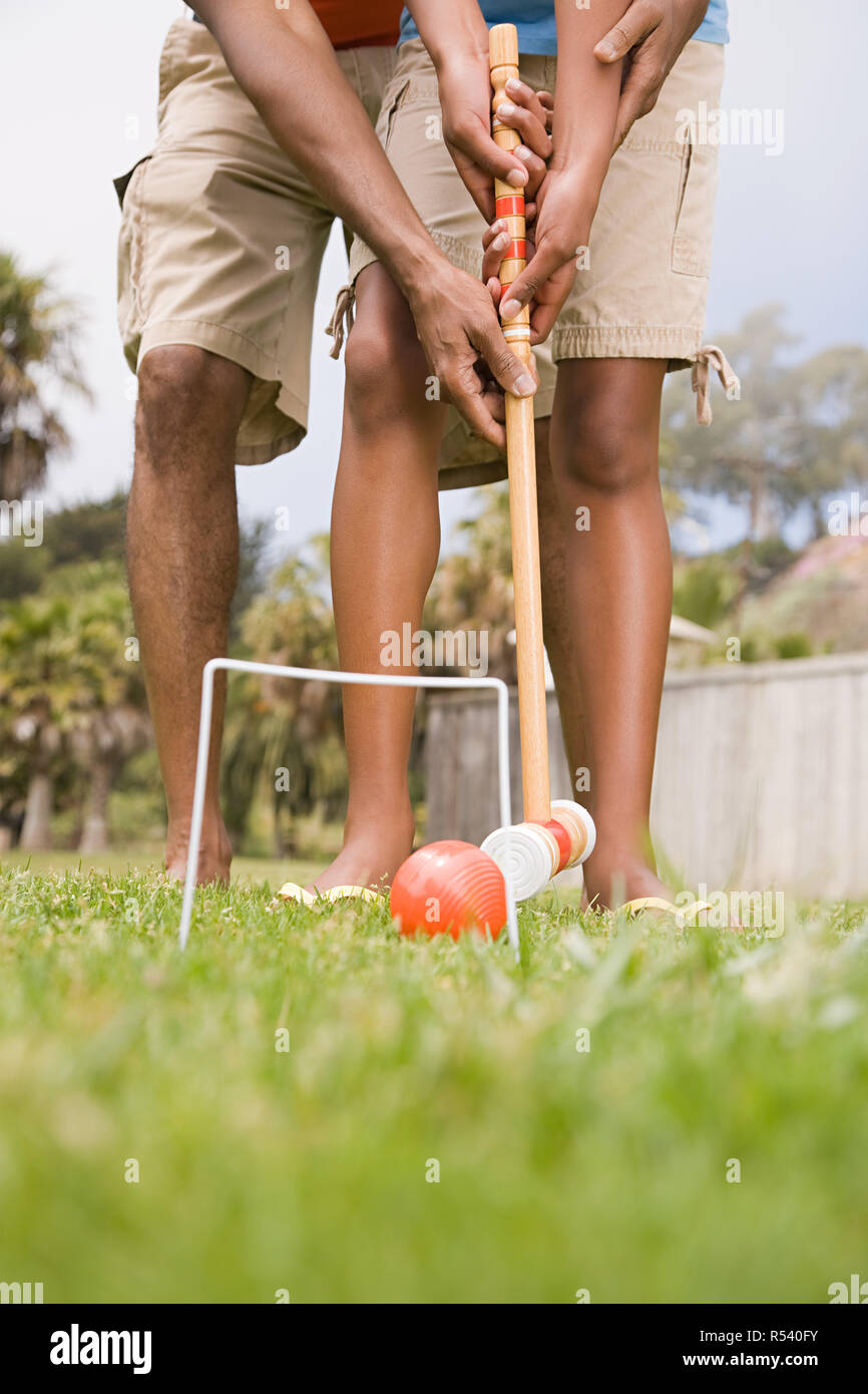 Two people playing croquet Stock Photo - Alamy
