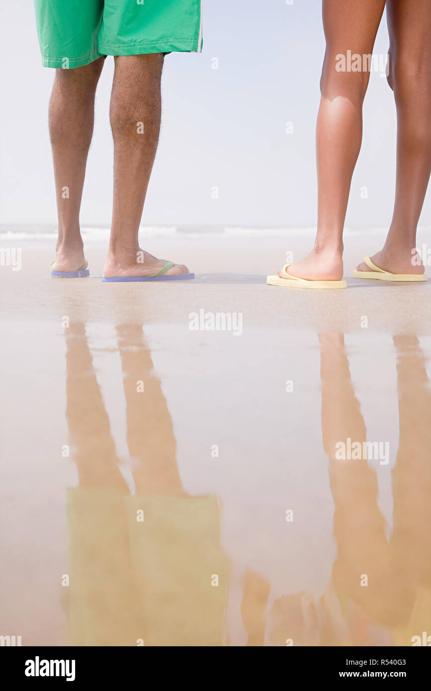 Two people standing on a beach Stock Photo - Alamy