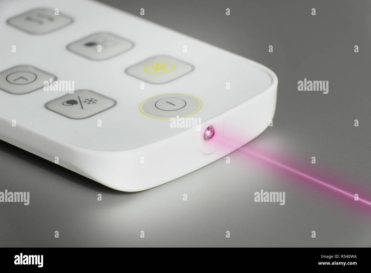 Close-up of a white remote control on metallic silver background Stock ...