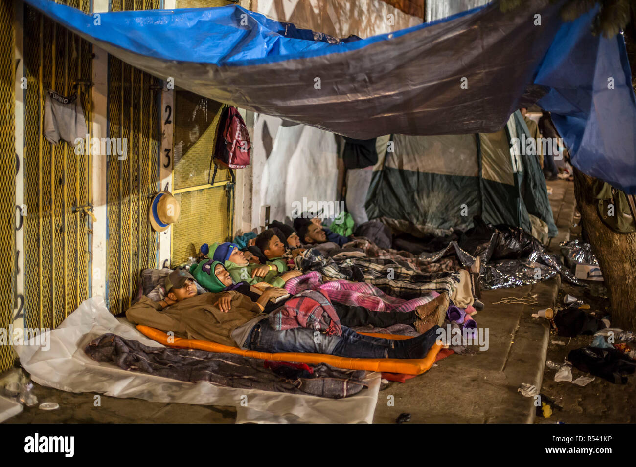 Tijuana, Mexico. 28th Nov, 2018. Migrants rest in front of the Benito ...