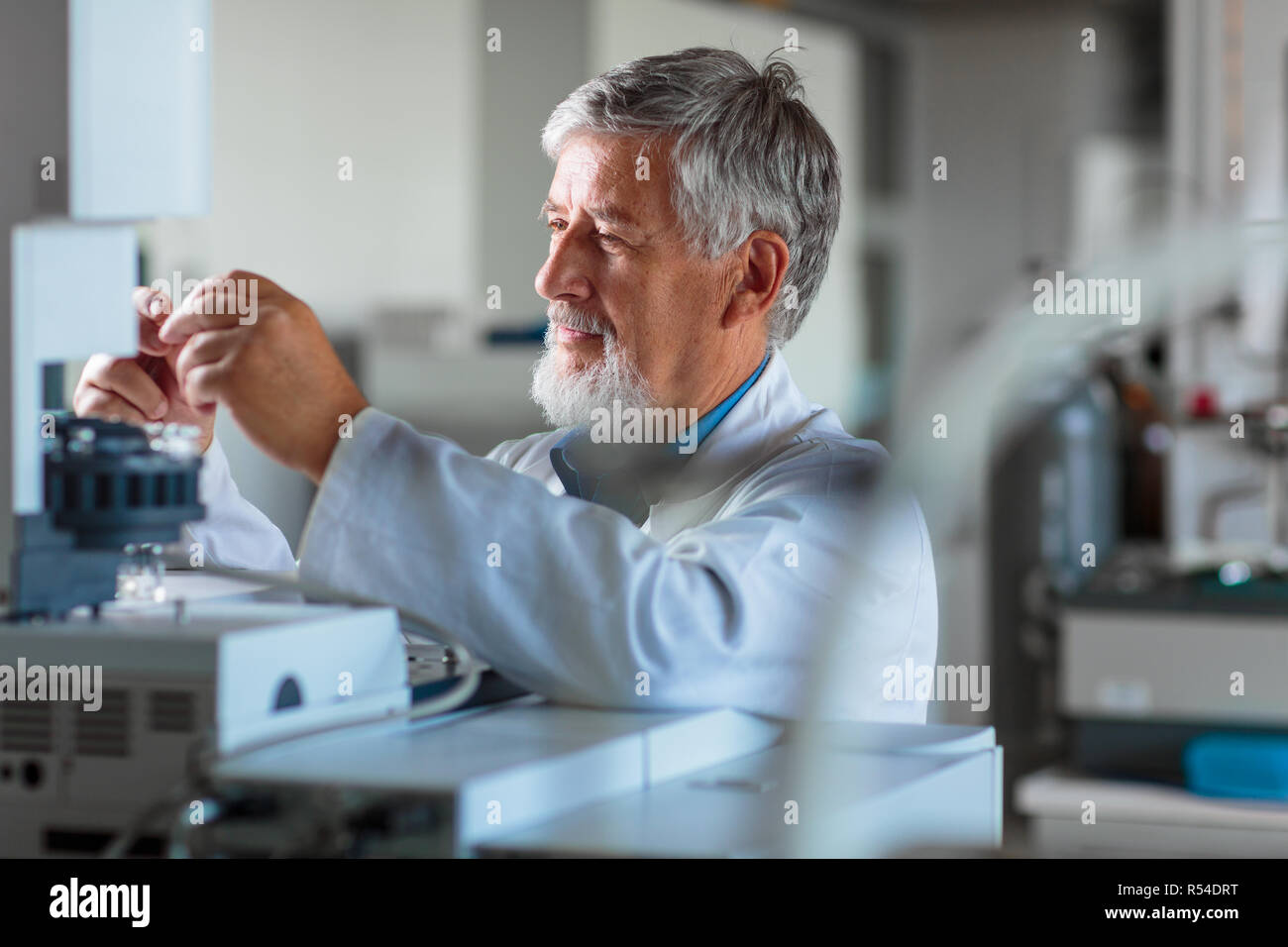 Senior chemistry professor/doctor carrying out research experiments in ...