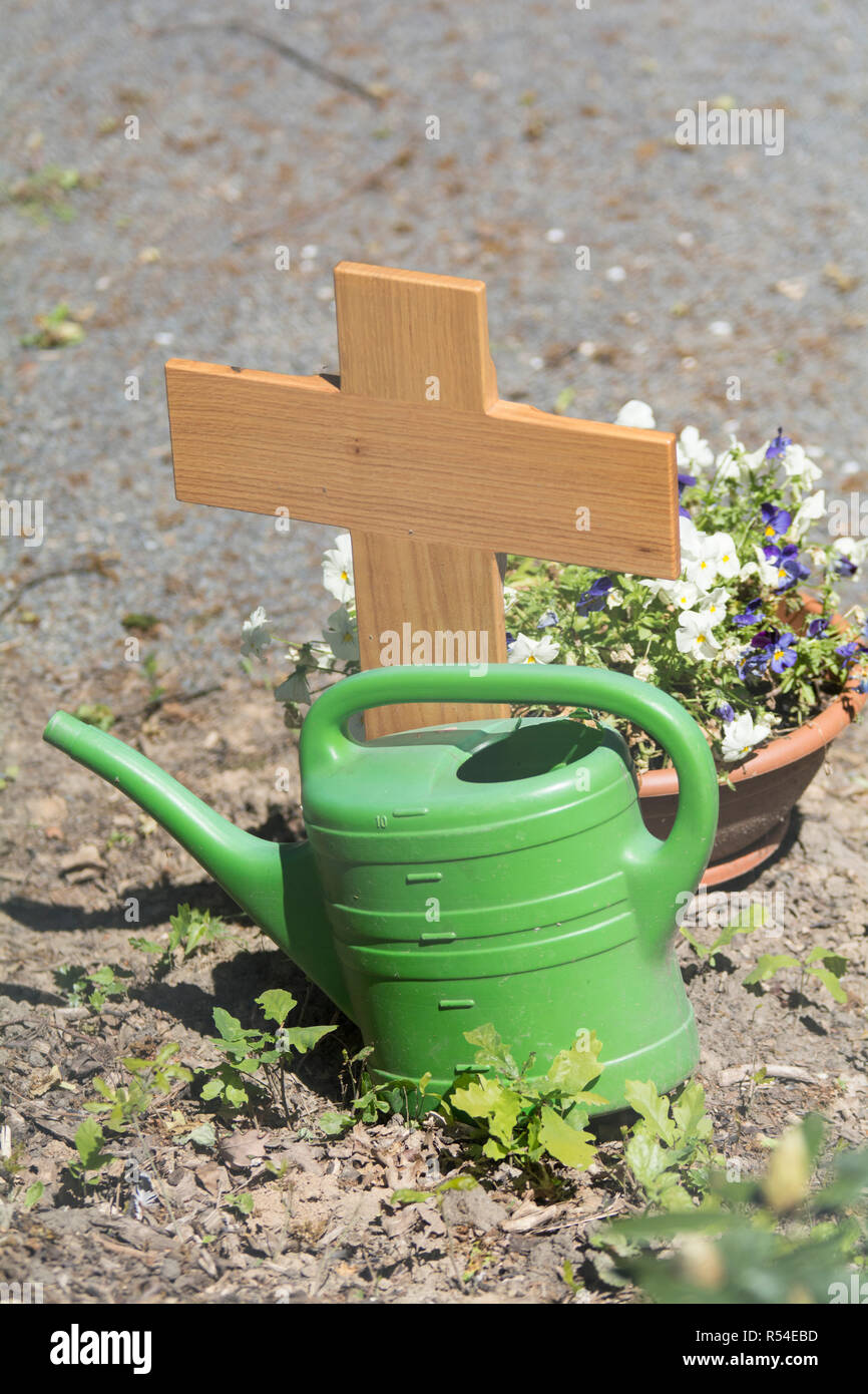 grave with watering can Stock Photo - Alamy