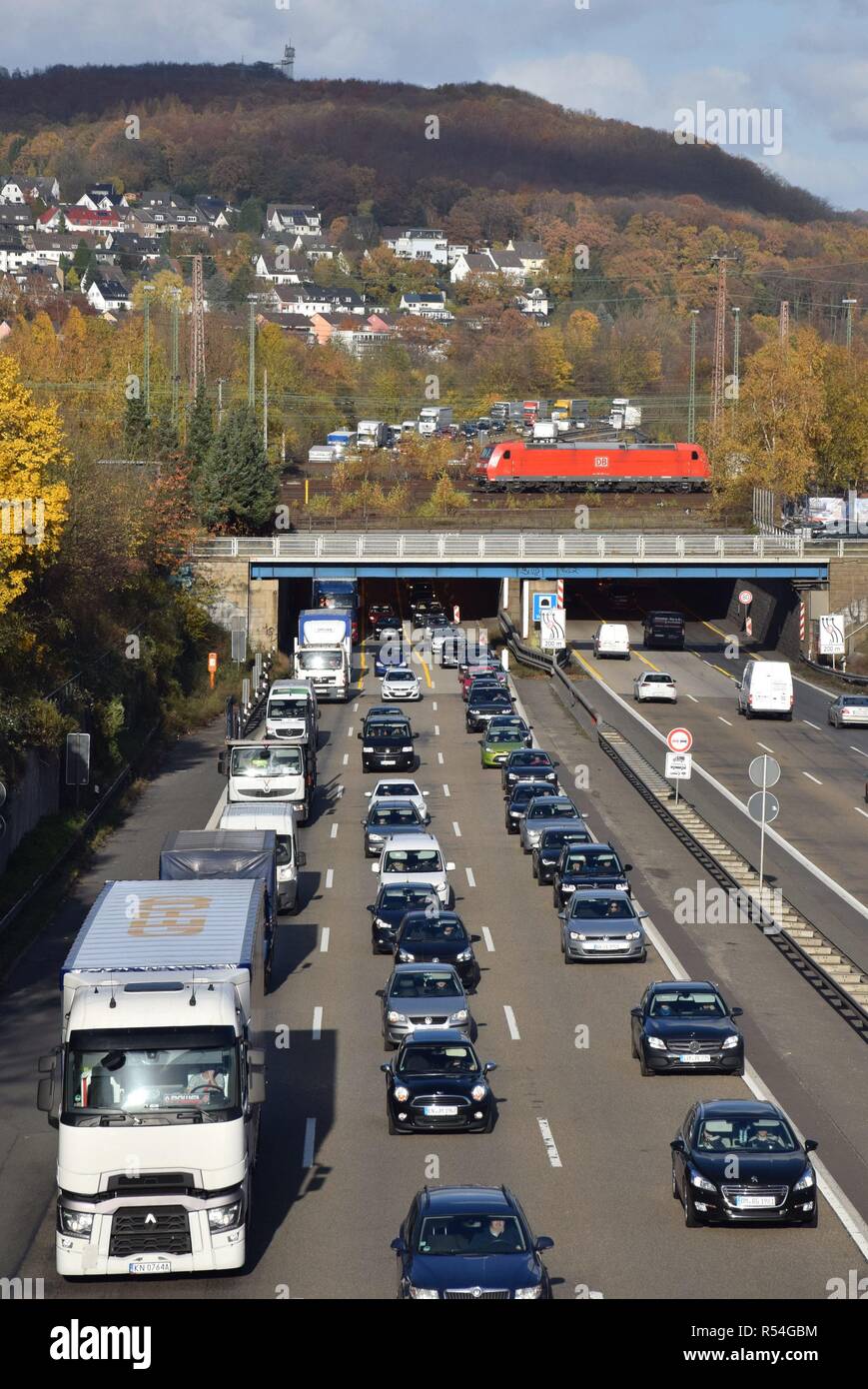 A railway line with freight train and a highway with traffic jam on 17. ...