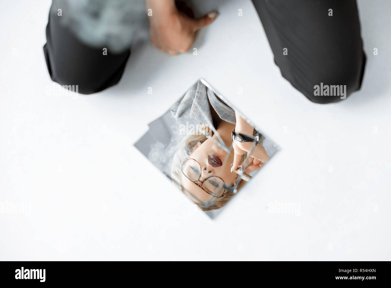 fashionable young woman smoking cigar, reflection in mirror Stock Photo ...