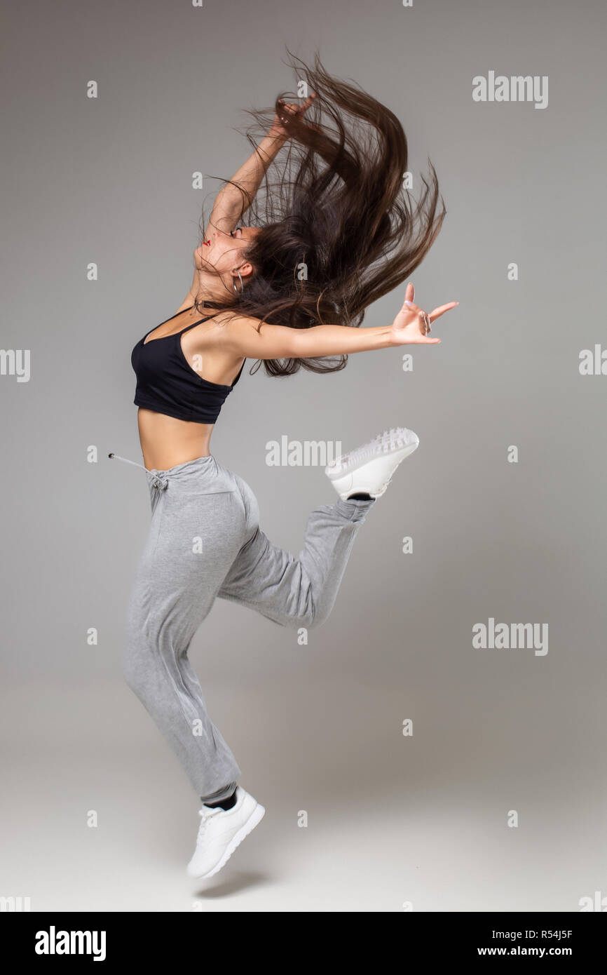 Modern style dancer posing on studio background. Dancing. Hobby. Hip ...