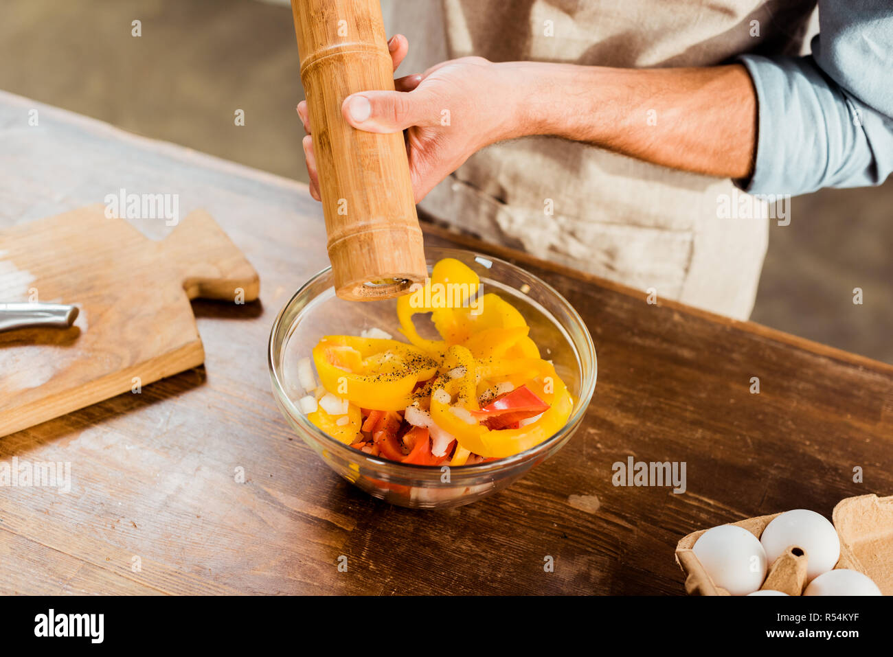 close-up partial view of man adding pepper with mill into salad Stock ...