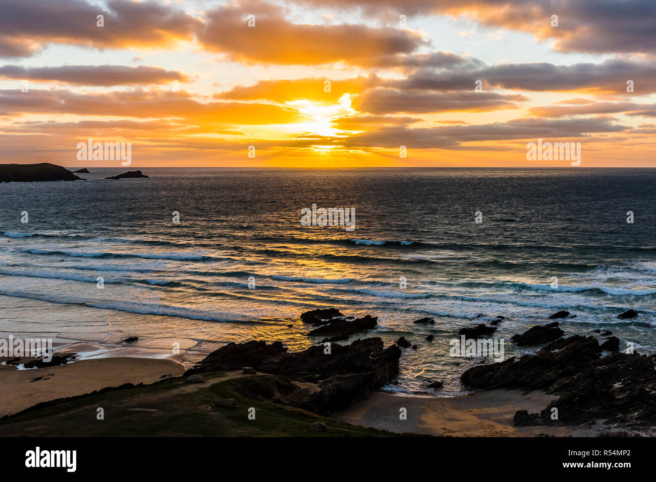 Sunset over a stormy Fistral Beach with surfers, Newquay, Cornwall, UK ...