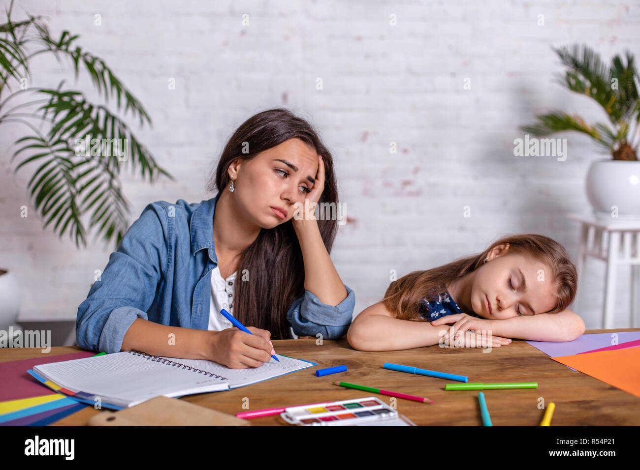 Mother becoming frustrated with daughter whilst doing homework sitting ...