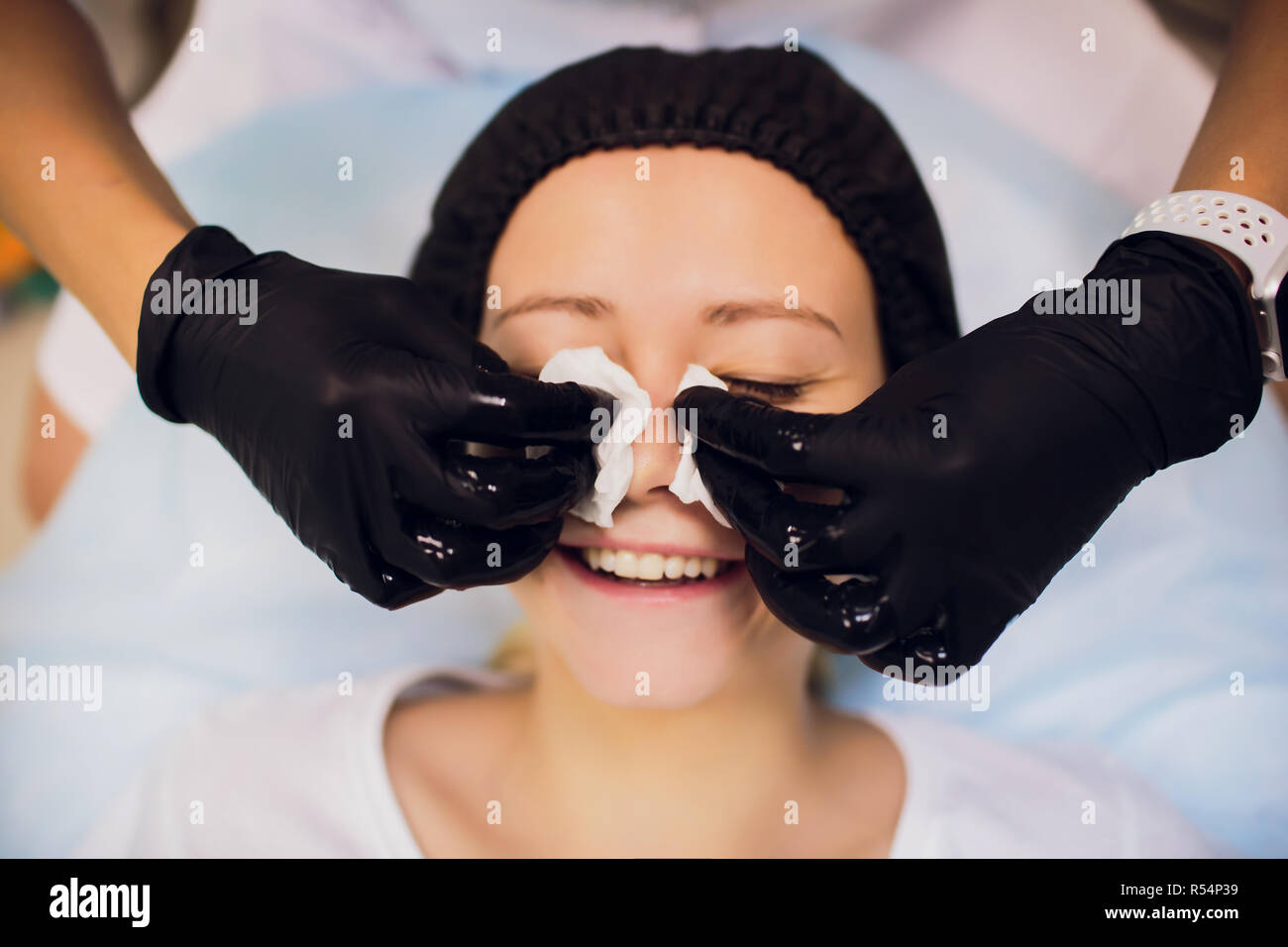 Wipe with sterile napkin face. Young woman receiving treatments in ...