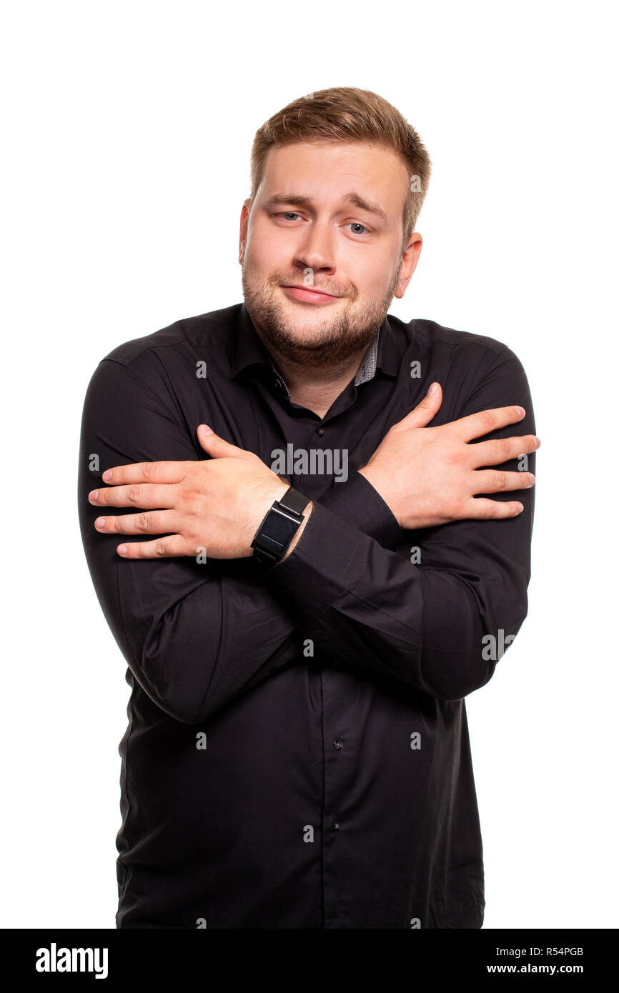 Guy on a white background freezes hugging myself. Body language Stock ...