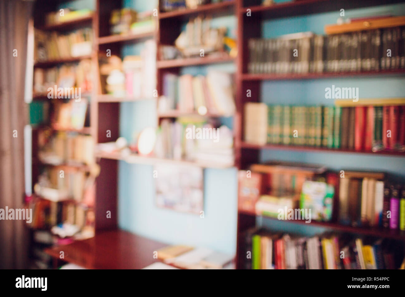 Books on bookshelf in library room, abstract blurred focused background ...