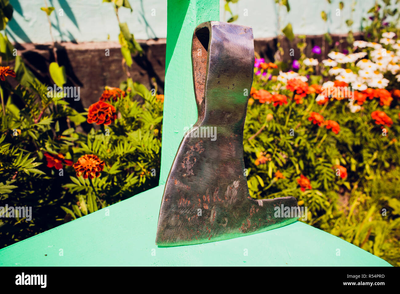 Rusty tip of sharp ax lies on edging boards Stock Photo - Alamy