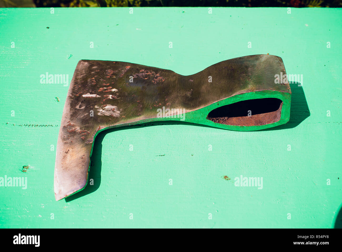 Rusty tip of sharp ax lies on edging boards Stock Photo - Alamy
