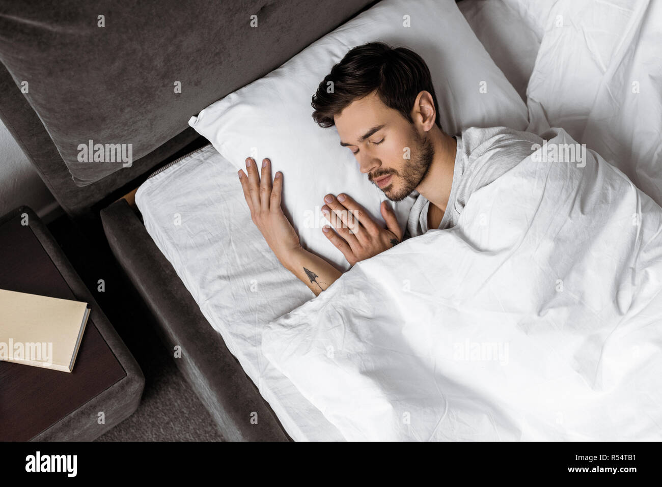 top view of handsome young man sleeping in bed in the morning Stock ...