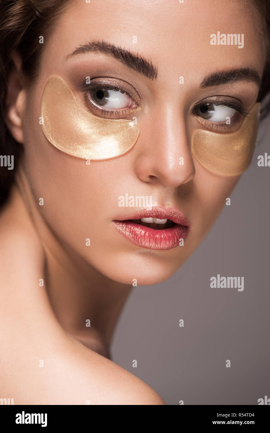 beautiful girl with golden eye patches, isolated on grey Stock Photo ...