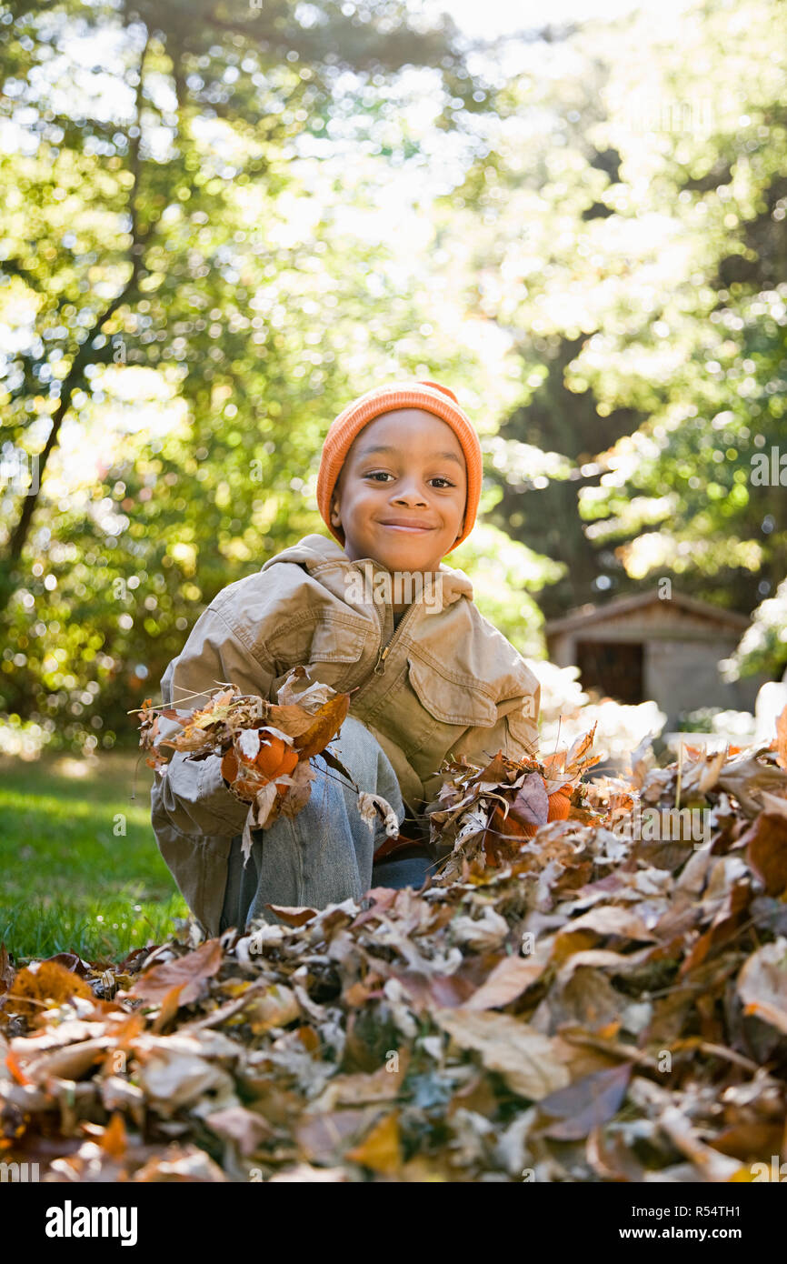 Boy holding leaves Stock Photo - Alamy