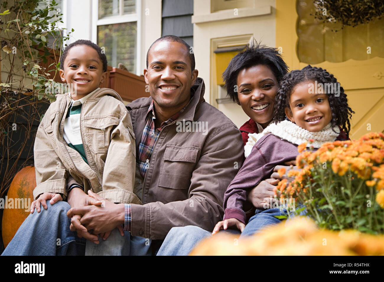 Family in front of house Stock Photo - Alamy