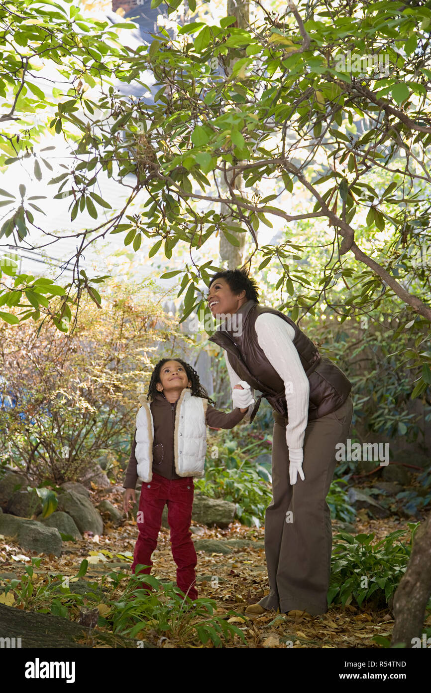 Mother and daughter under tree Stock Photo - Alamy