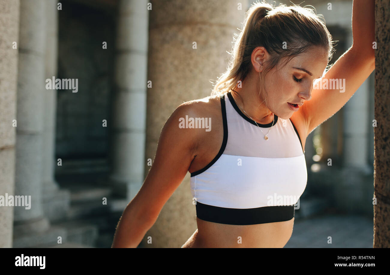 Portrait of a fitness woman relaxing during workout standing with eyes ...