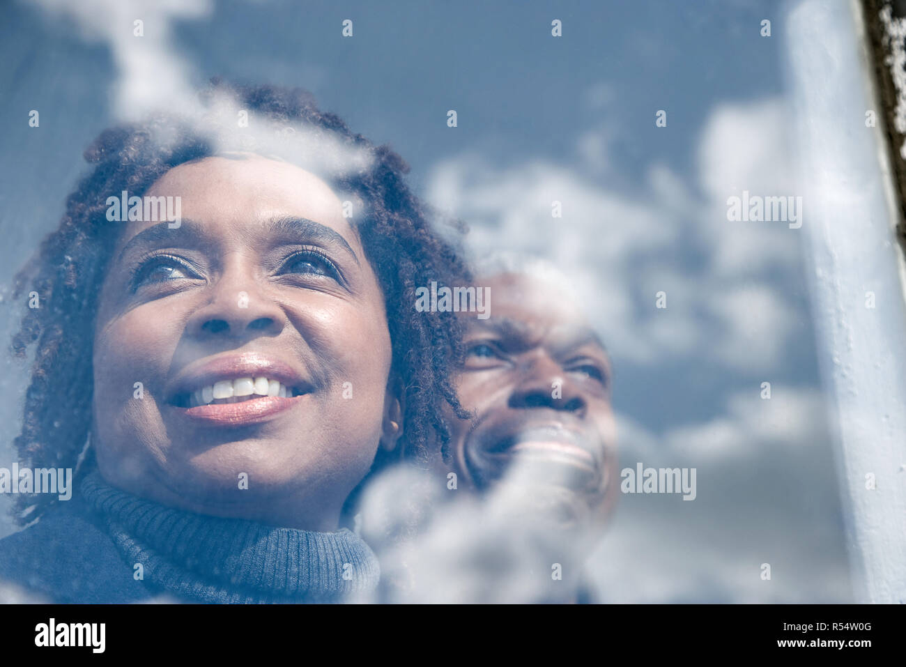 Man peeking out of a window hi-res stock photography and images - Alamy