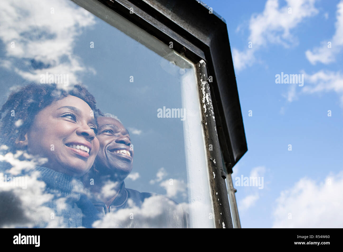 Man peeking out of a window hi-res stock photography and images - Alamy