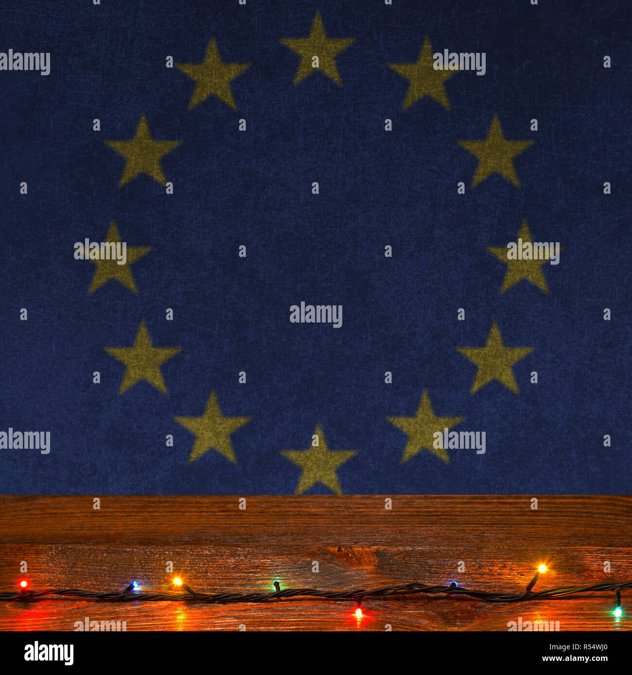 Festive grunge background with Christmas lights on a wooden surface and ...