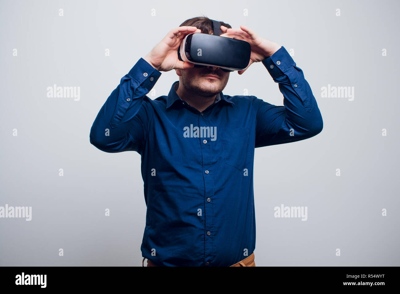 Young man using VR glasses headset trying to touch objects in virtual ...