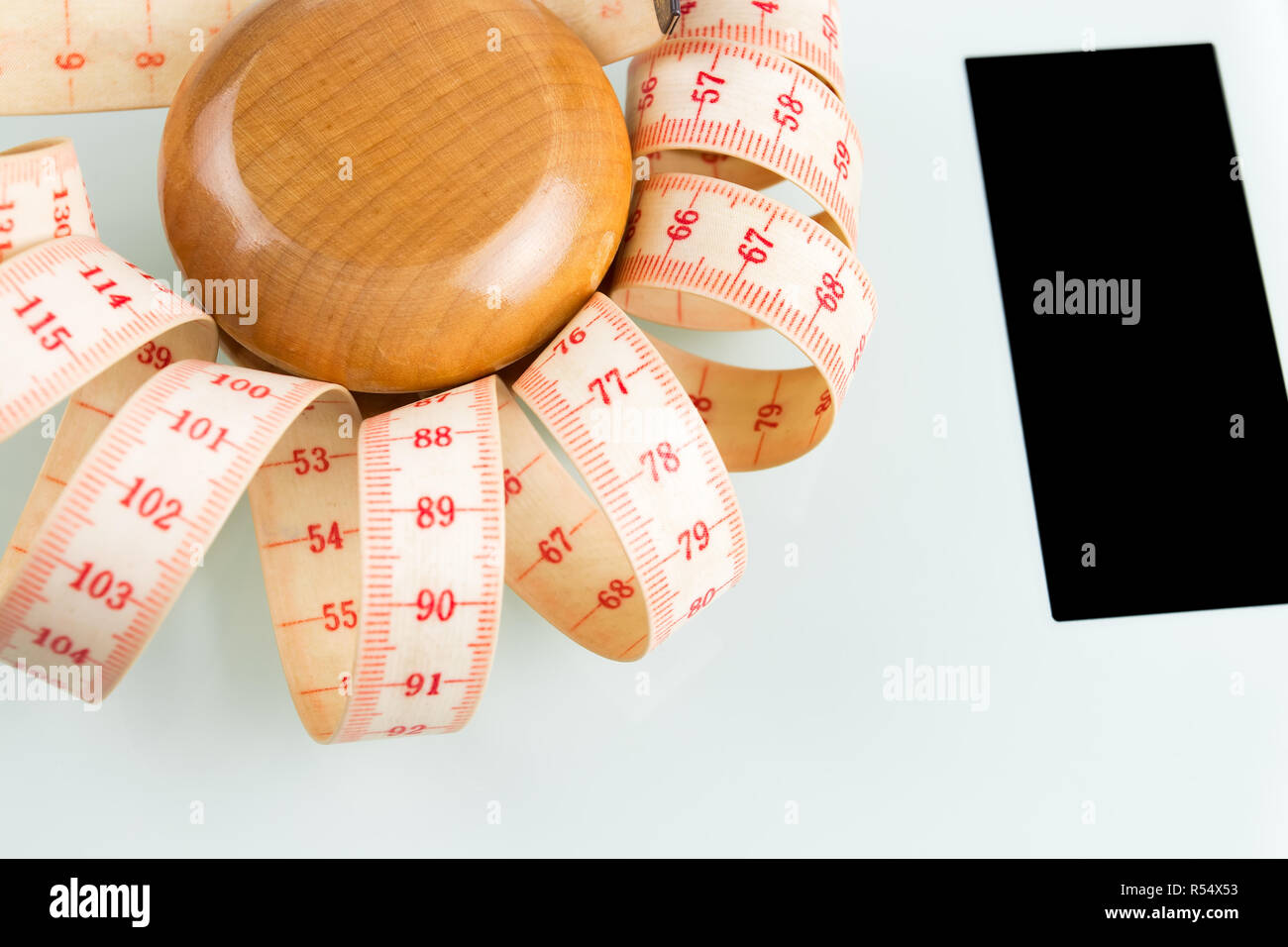 Yo-yo effect in diet concept. Wooden yoyo with centimeter measure ...
