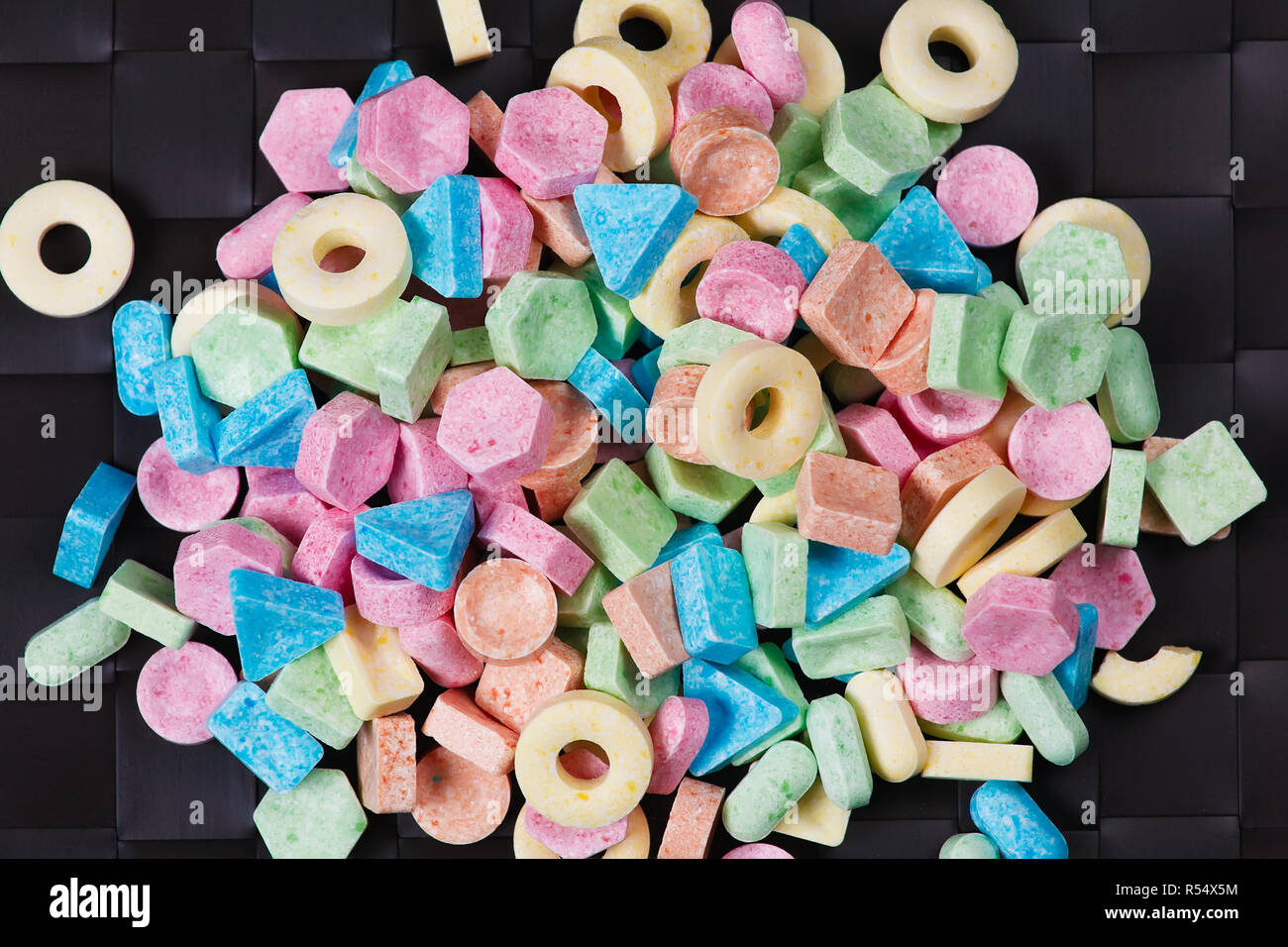 Pile of colorful sweet candy on black checkered background Stock Photo ...