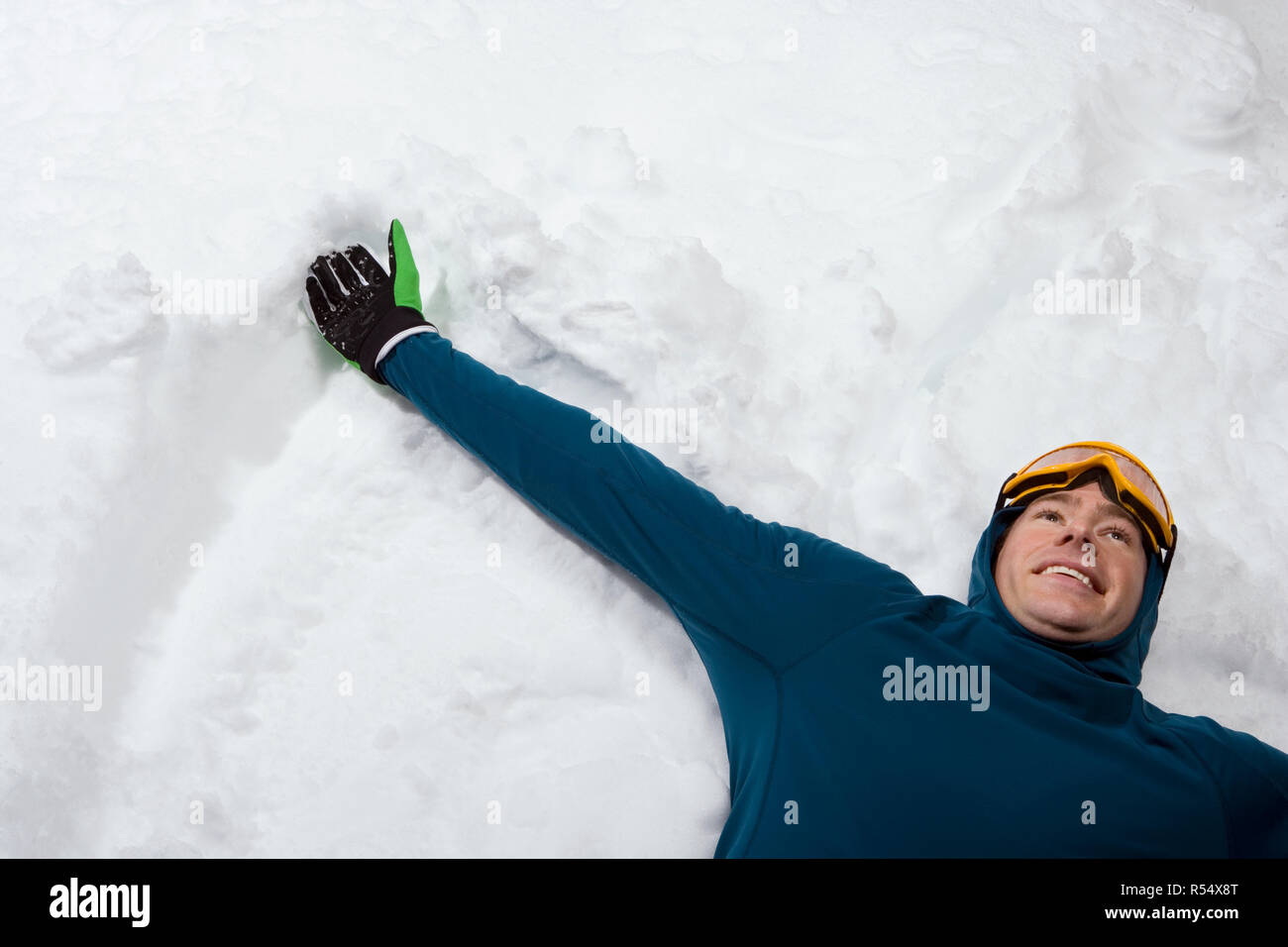 man making snow angels Stock Photo - Alamy