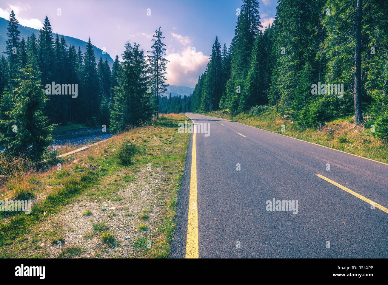 Mountain road. Landscape with rocks, sunny sky with clouds and ...