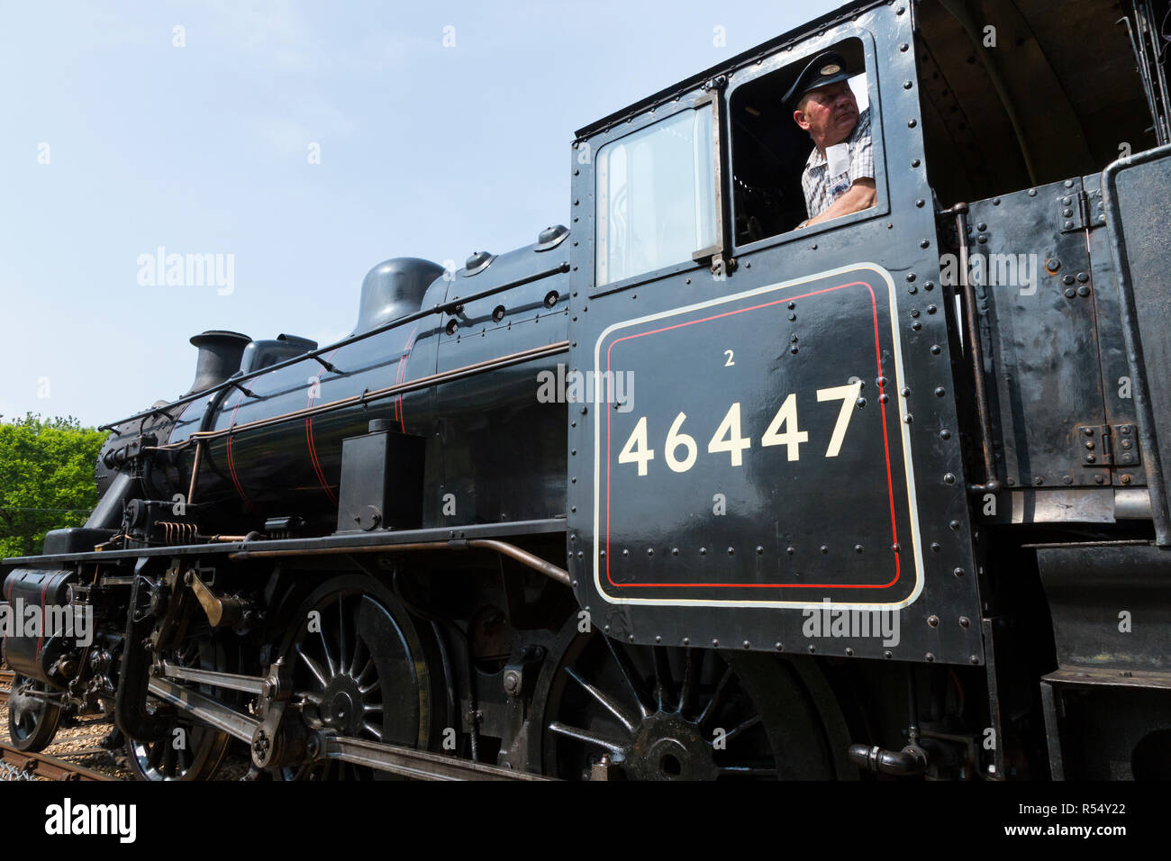 Steam engine number 46447 and locomotive train driver running / working ...