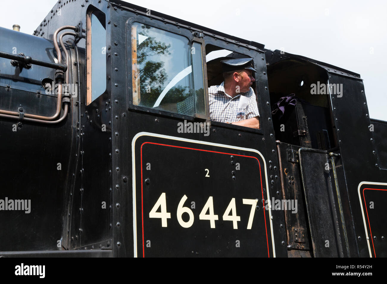 Steam engine number 46447 and locomotive train driver running / working ...