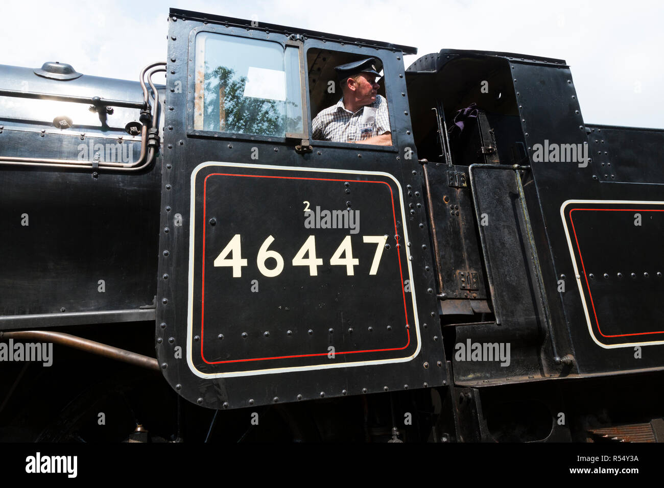 Steam engine number 46447 and locomotive train driver running / working ...
