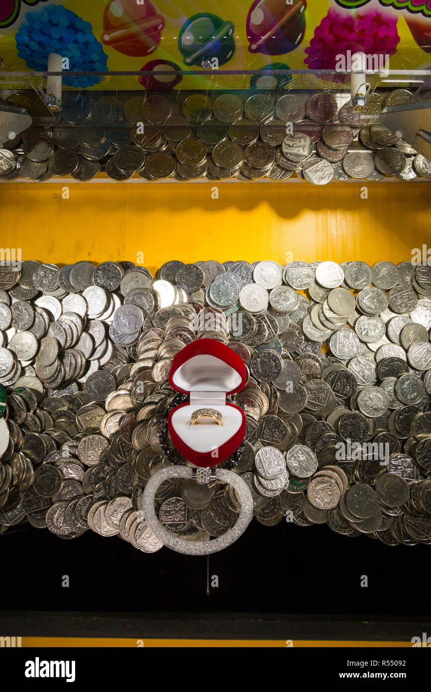 Ten pence 10p coins waiting to fall and be won ( or lost and go to the ...