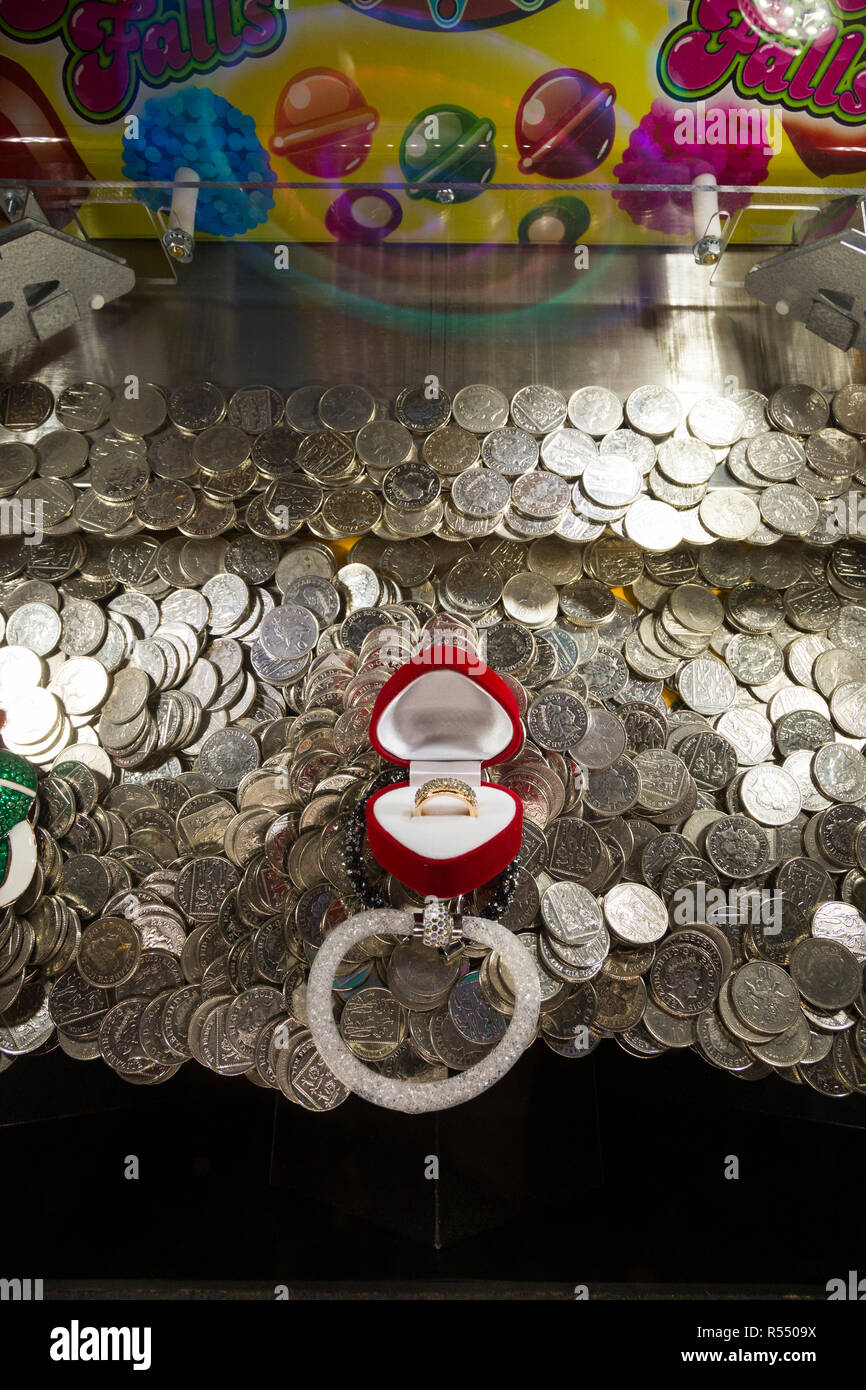 Ten pence 10p coins waiting to fall and be won ( or lost and go to the ...