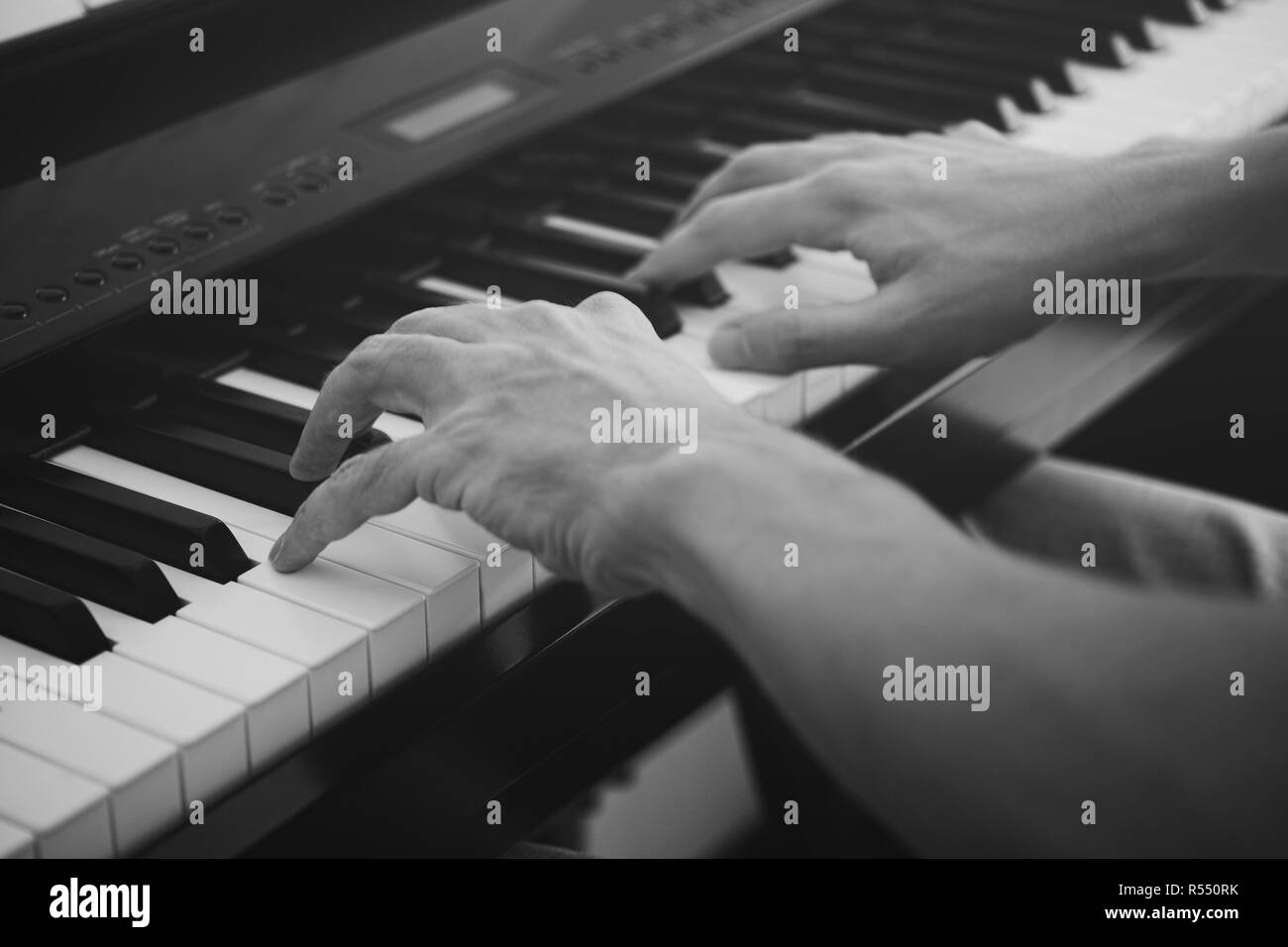 Black Hands Playing Piano