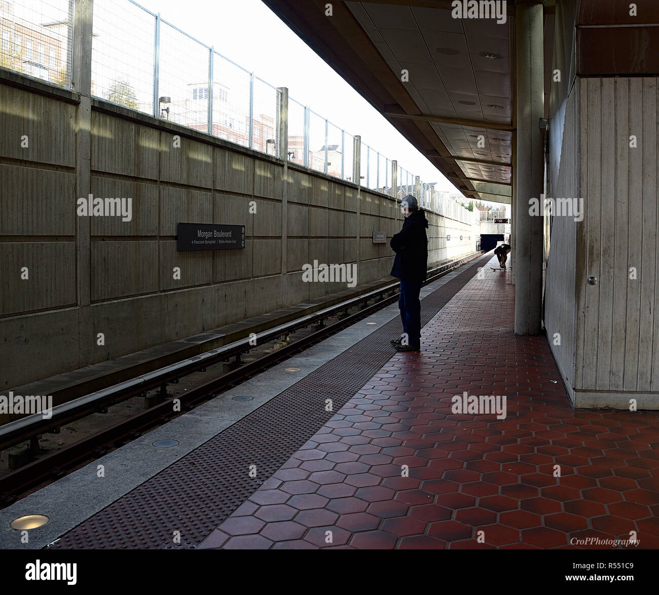 man standing alone while waiting for metro train Stock Photo - Alamy