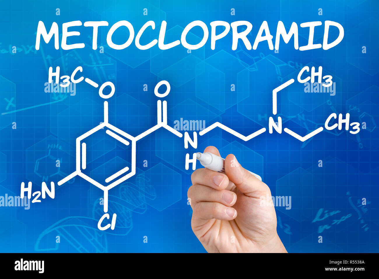 hand with pen draws chemical structural formula of metoclopramide Stock ...