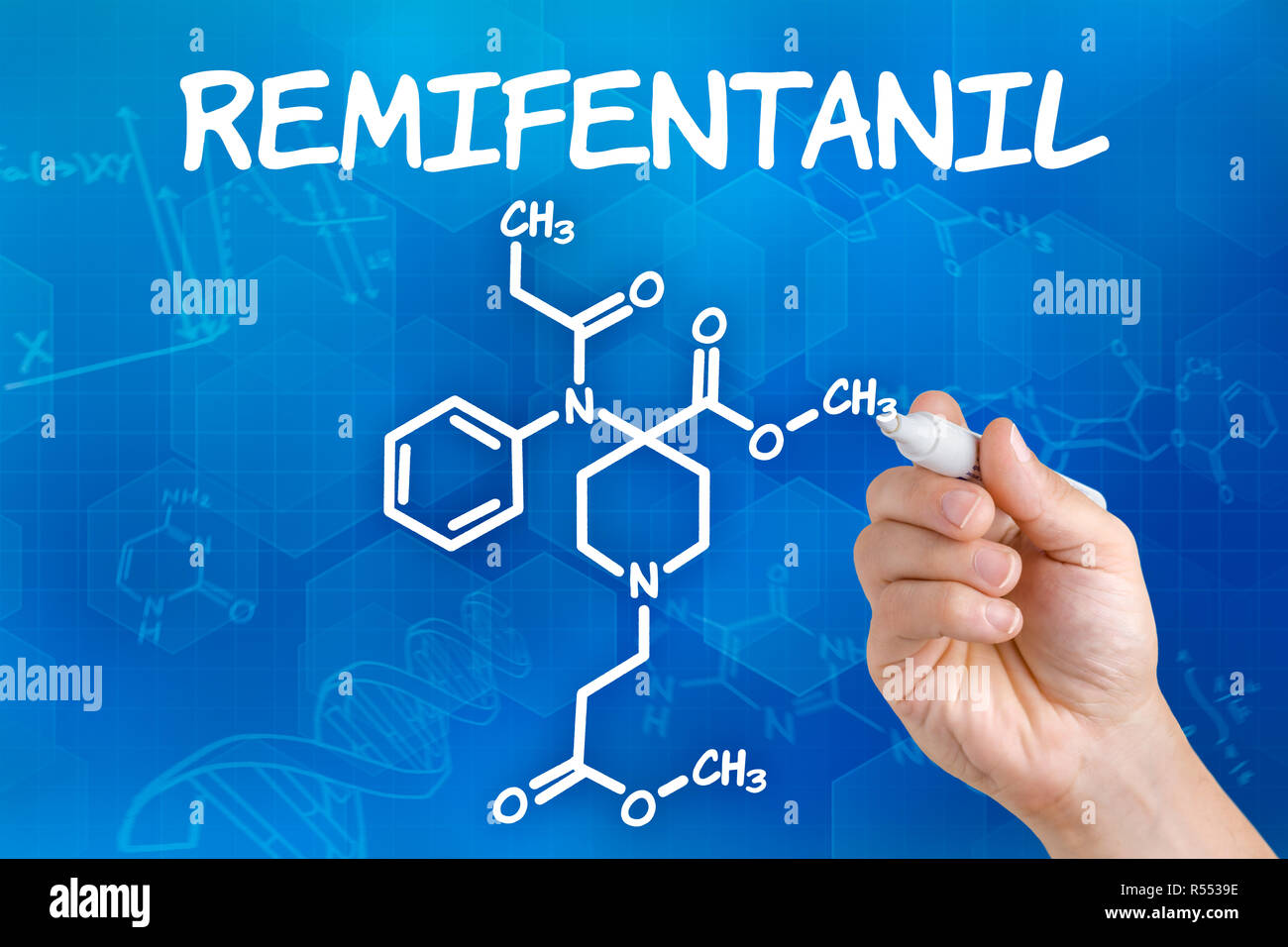 hand with pen draws chemical structural formula of remifentanil Stock ...