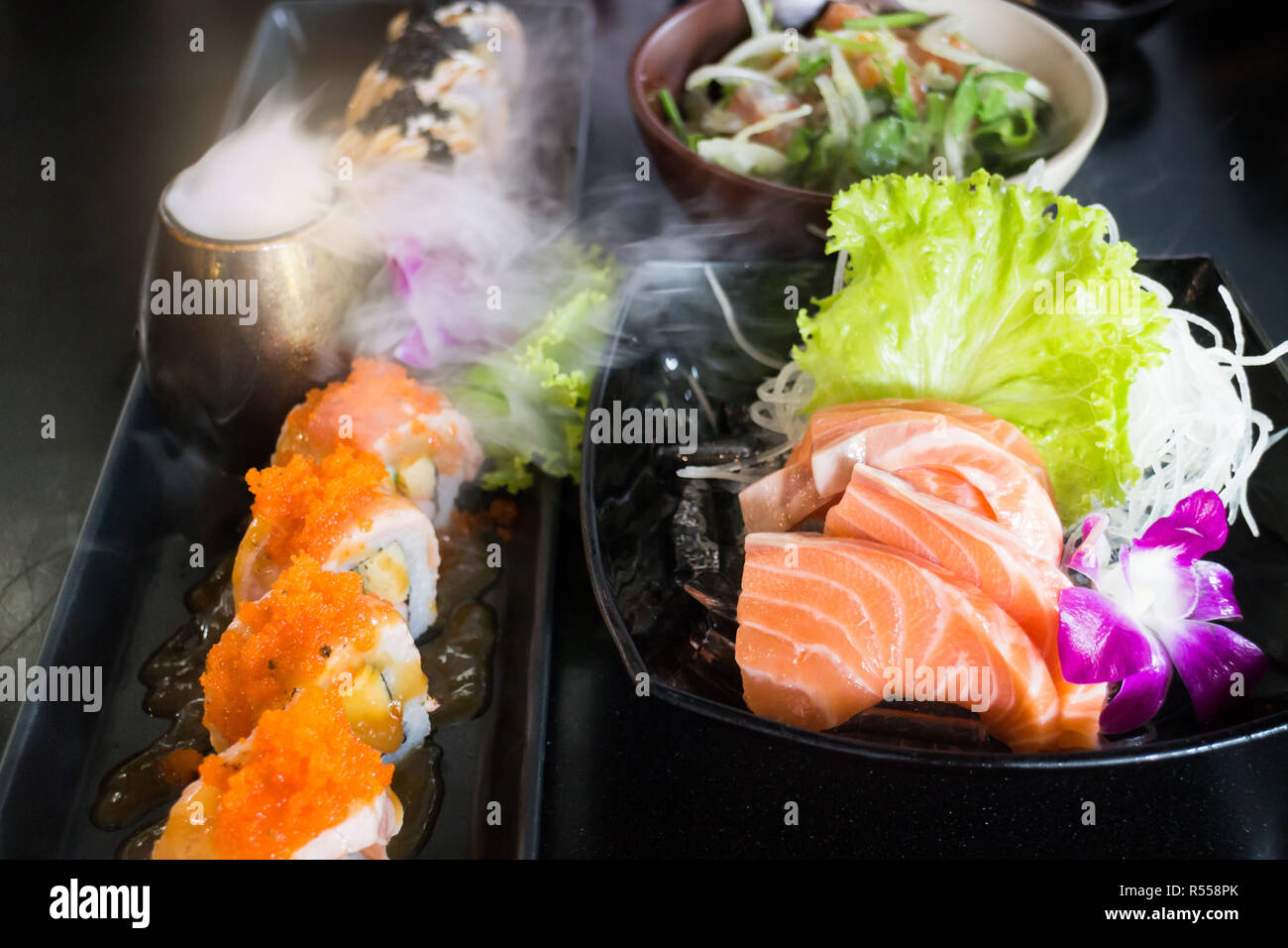 Set Of Salmon Menu Served On Black Plate Stock Photo - Alamy