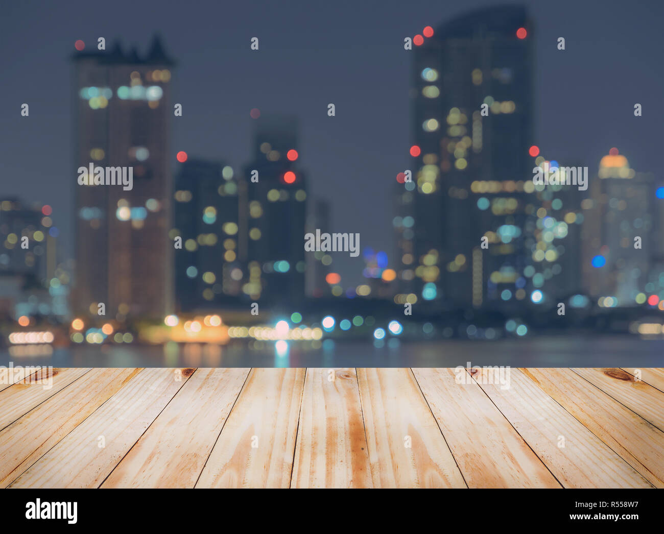 Empty wooden table with blurred city skyline background at night Stock ...
