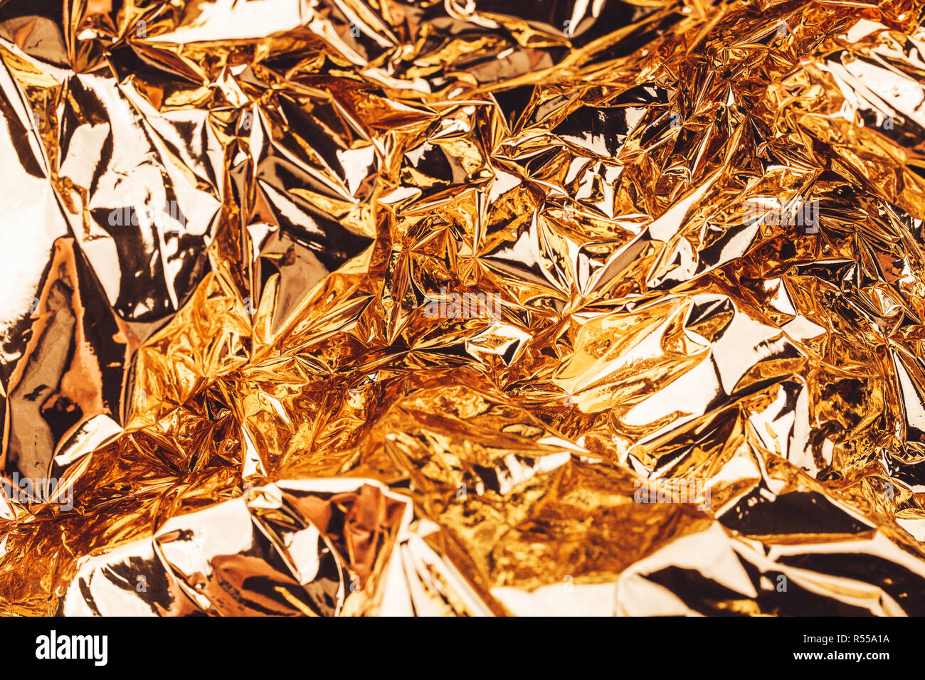 Golden abstract background made of wrinkled golden paper Stock Photo ...