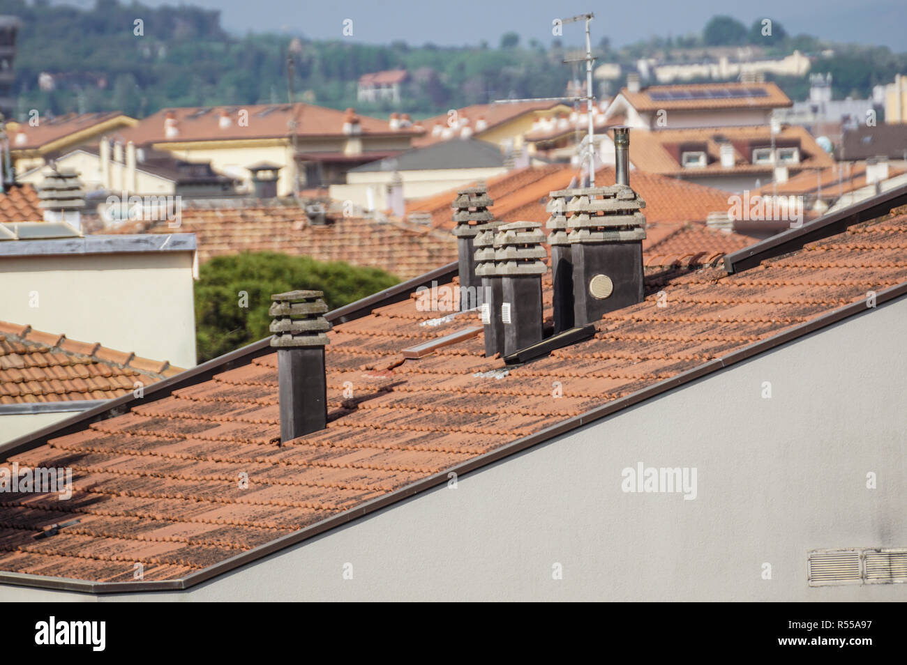 Old clay chimney pots and brick chimney stacks on old tiled roof ...
